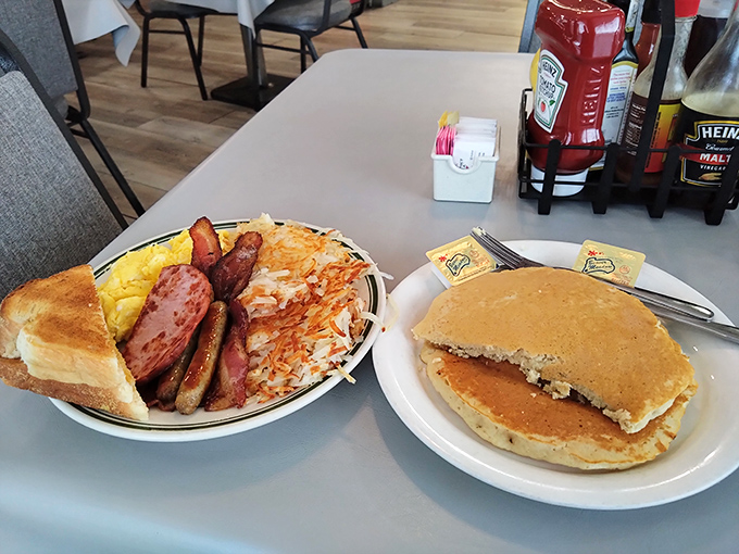 The breakfast of champions isn't a cereal box—it's this magnificent spread of eggs, meats, and pancakes that would make any morning magnificent.