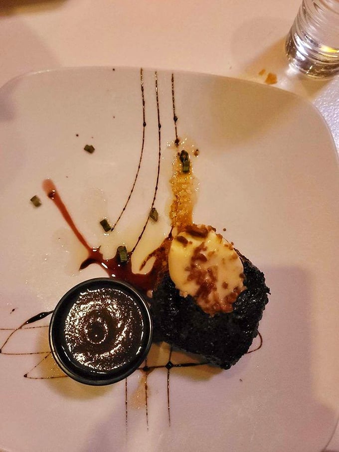 Dessert that demands a moment of silence. This flourless chocolate creation with its artful presentation proves steakhouses take their sweet finales seriously too. 