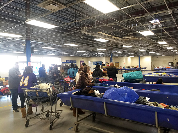 The unspoken choreography of outlet shopping &ndash; carts positioned strategically, eyes scanning constantly, the universal language of the bargain hunt.