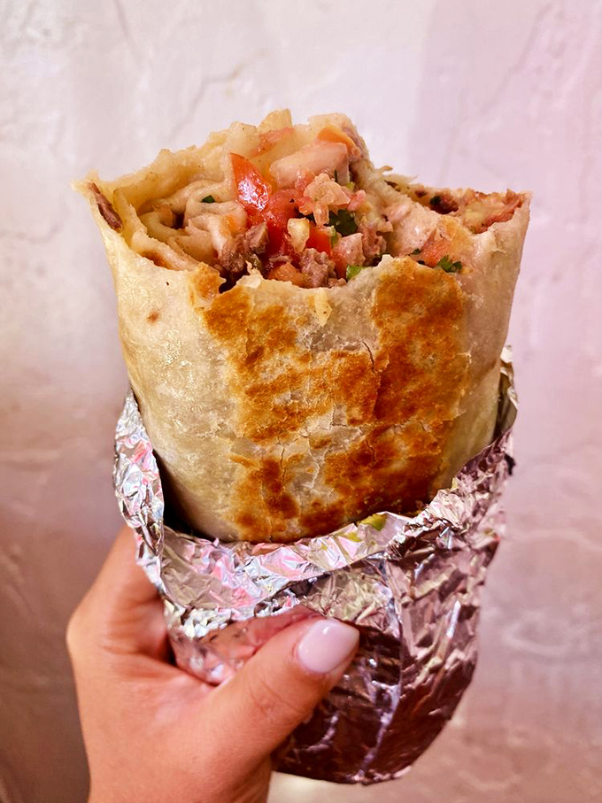 Held aloft like the trophy it is, this foil-wrapped champion shows its golden-griddled exterior. The perfect handheld meal, no utensils required.