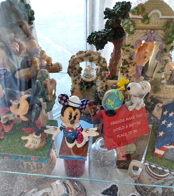 Collectible figurines behind glass tell stories of previous homes. That Snoopy figure might have watched over someone's childhood from a bedroom shelf.