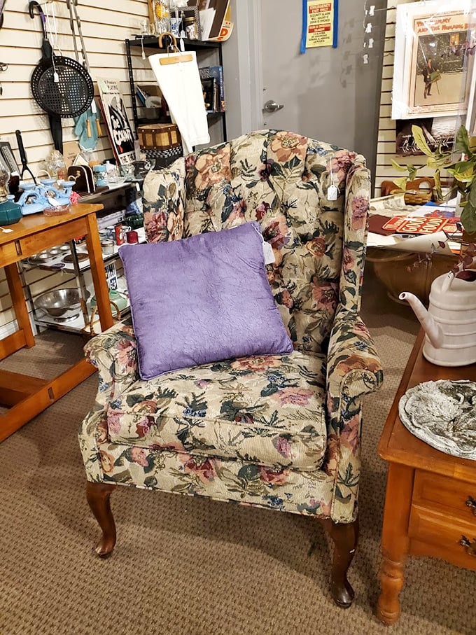 A floral armchair that's seen more family dramas than a season of "This Is Us." That purple pillow is just asking for a Sunday afternoon nap.