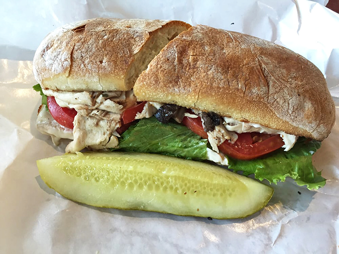 Fresh ingredients shine in this chicken sandwich masterpiece. The pickle stands guard, knowing you'll need its tangy crunch between bites.