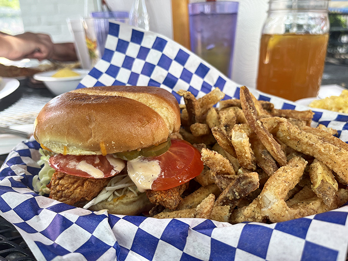 Sandwich architecture at its finest &ndash; crispy meets creamy meets fresh. The fries aren't sidekicks; they're co-stars in this production.