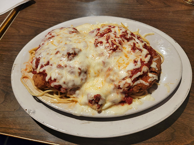 Chicken parmesan that requires its own zip code, smothered in enough cheese to make Wisconsin jealous.