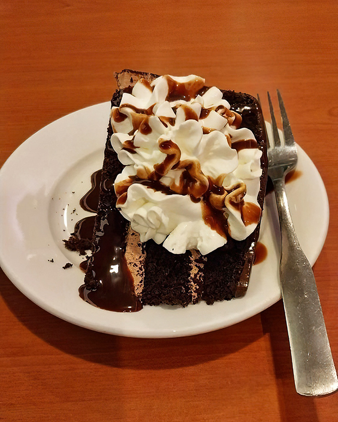 This chocolate cake isn't just dessert&mdash;it's therapy on a plate, with whipped cream and caramel drizzle playing supporting roles in your moment of bliss.