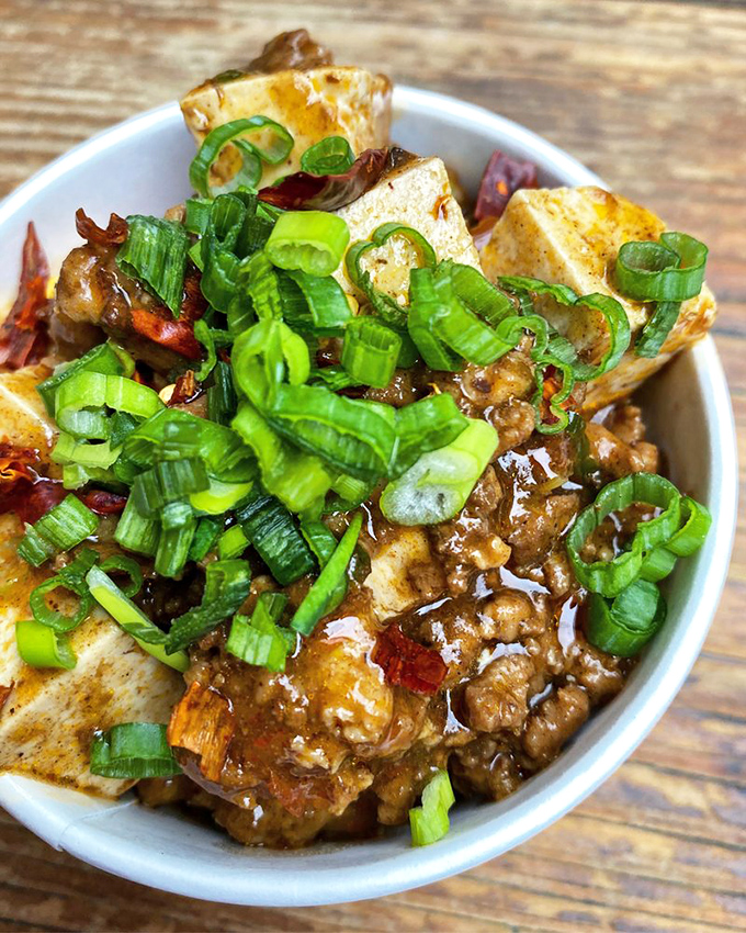Tofu that's having an identity crisis in the best possible way. Those green onions aren't garnish&mdash;they're exclamation points.