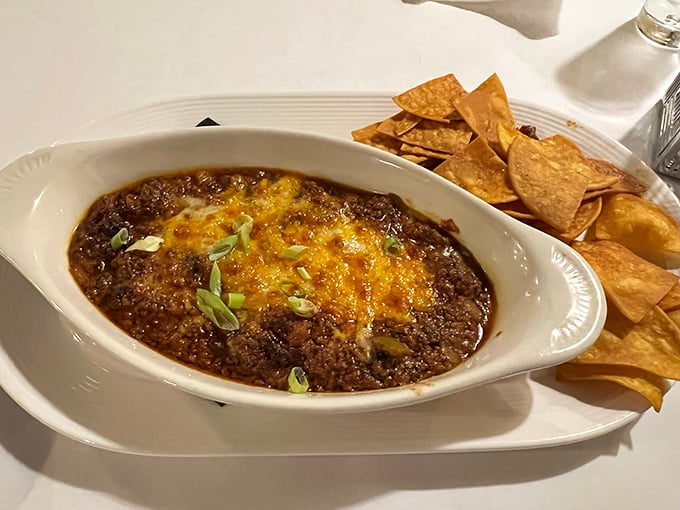 This bubbling chorizo dip with melted cheese could start a religion. The crispy tortilla chips are merely vehicles for this savory masterpiece. 