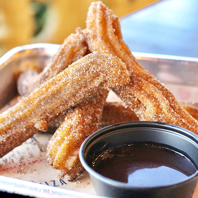 Churros that have achieved the impossible trifecta: perfectly crisp exterior, tender interior, and a cinnamon-sugar coating that will definitely end up on your shirt.