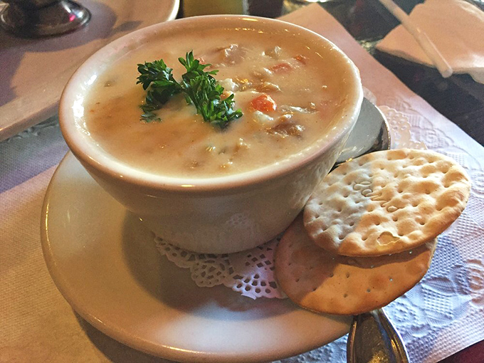 Clam chowder served with proper crackers and doily-lined plates. Comfort in a bowl that would make even a rainy London day seem cheerful.