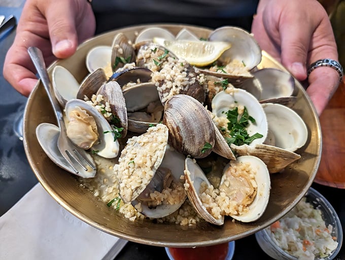 These clams aren't just steamed&mdash;they're a briny celebration on a plate, garnished with herbs and demanding to be savored one delicious shell at a time.