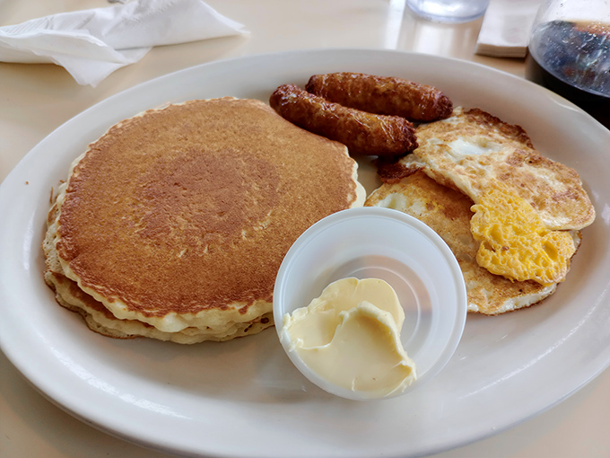 The breakfast plate that launched a thousand productive days &ndash; golden pancake flanked by sunny eggs and sausage standing at attention.