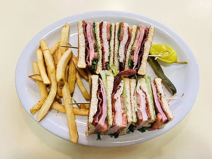 The club sandwich stands tall and proud, layers stacked with military precision&mdash;a skyscraper of flavor requiring strategic demolition techniques.