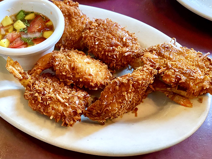 Coconut shrimp with a tropical salsa &ndash; crispy, golden treasures that bring unexpected flair to this traditional Italian menu.