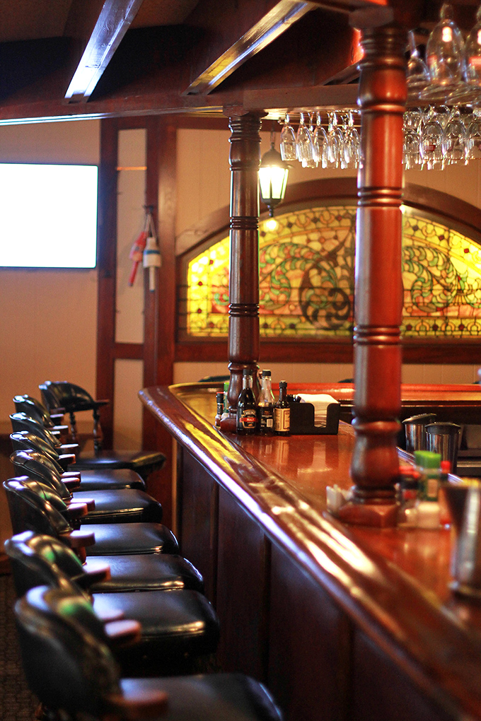 This isn't just a bar counter; it's front-row seating to the artistry of proper cocktail making, with stained glass adding a touch of vintage elegance.