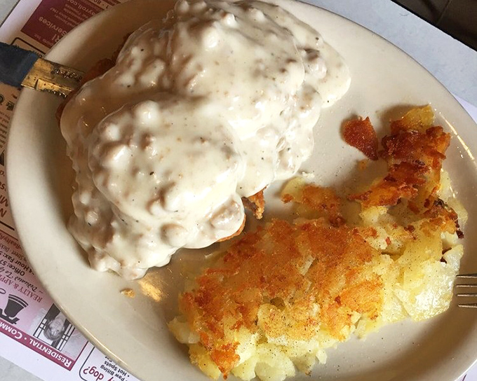 This isn't just country fried steak&mdash;it's a gravy-laden masterpiece that renders conversation impossible except for appreciative mumbling. Those hash browns deserve their own fan club. 