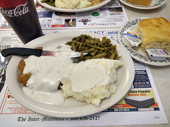 Country fried steak smothered in gravy that could make a vegetarian question their life choices. Pure Appalachian comfort on a plate.