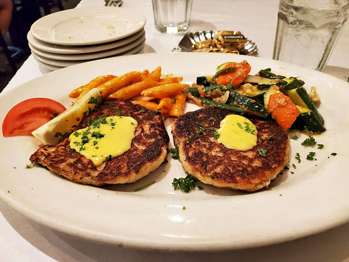 Crab cakes so perfectly golden they deserve their own Olympic medals, with a side of vegetables pretending anyone's paying attention to them.