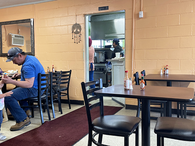 The dining room tells the real story: simple tables, working folks enjoying authentic food. No pretension, just the pursuit of delicious satisfaction.