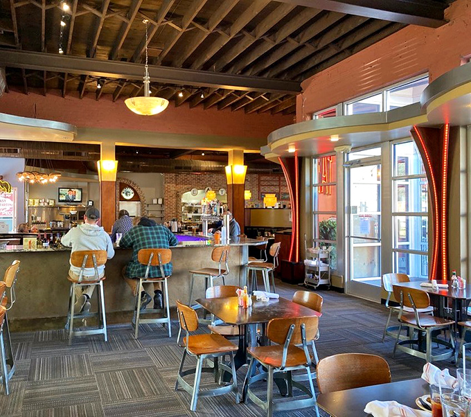 Morning rituals unfold at the counter, where regulars perch on wooden stools, trading stories over steaming mugs of coffee.