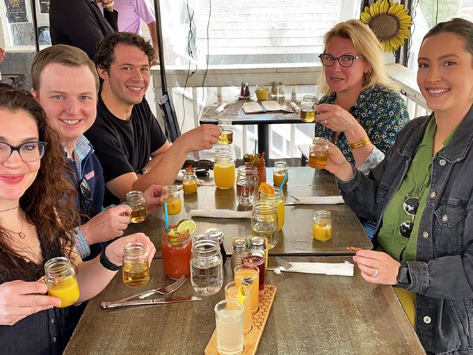 Nothing says "we made the right breakfast choice" like a table full of colorful drinks in mason jars and friends raising a toast to morning indulgence.