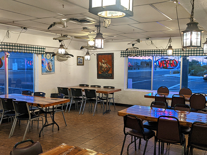 Evening light filters through windows, casting a blue glow that transforms this simple dining room into an underwater grotto.