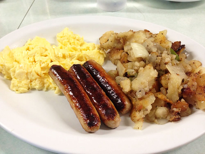 Scrambled eggs and sausage links demonstrating that sometimes the simplest combinations create pure breakfast perfection.