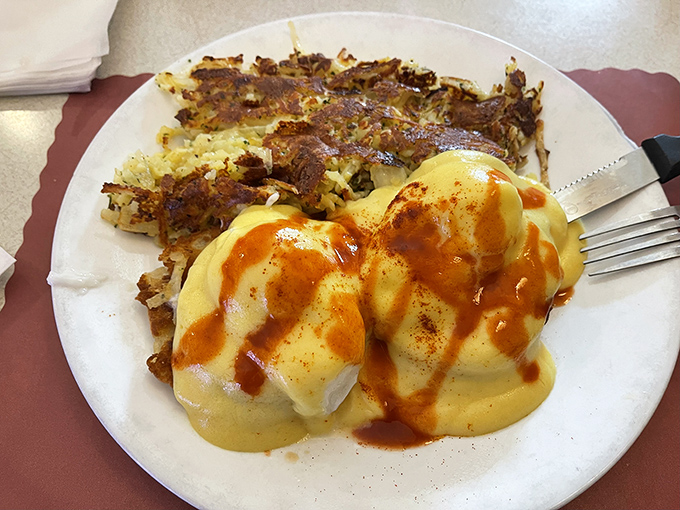 Eggs Benedict with a side of crispy hash browns – breakfast's power couple that never disappoints and always satisfies.