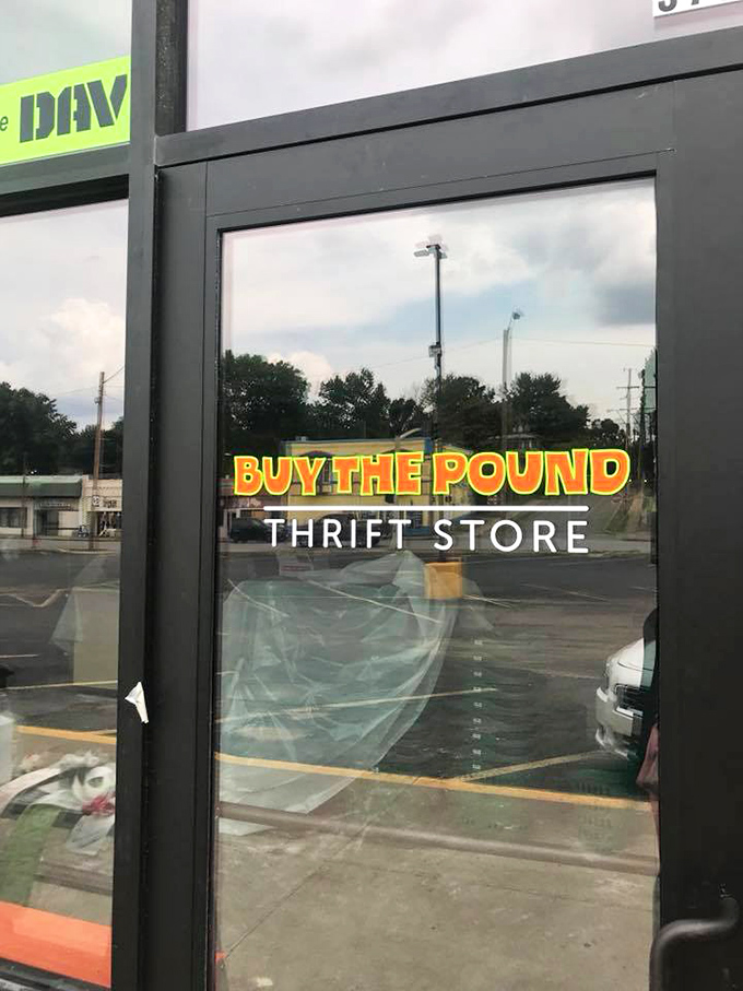 Glass doors frame the promise of bargains, reflecting both sunshine and shoppers' anticipation.
