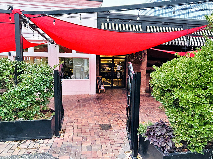 The entrance pathway, with its red sail awning and lush greenery, feels like the opening scene to your own personal food adventure movie.