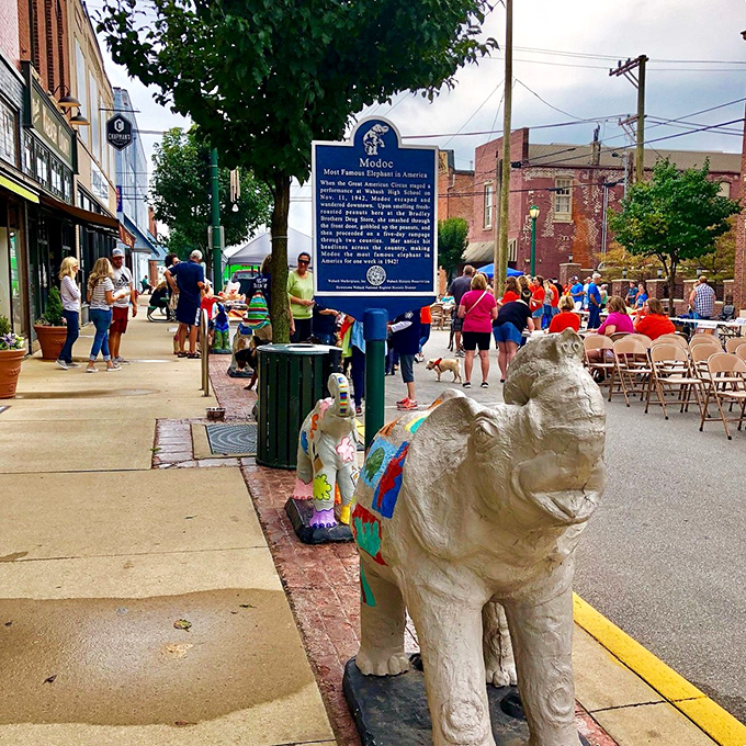 Community gatherings in Wabash happen right on the sidewalk, where colorful elephant sculptures meet colorful characters. Small-town America in full bloom.
