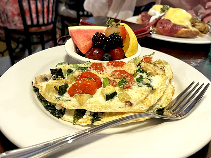 An omelet that's practically a farmer's market in every bite, paired with fresh fruit that reminds you why Virginia's produce deserves its reputation.