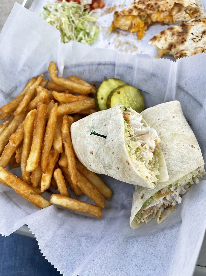 The fish taco wrap&mdash;ocean meets garden, all tucked neatly into a tortilla. Those perfectly golden fries are the supporting actors who consistently steal the scene.