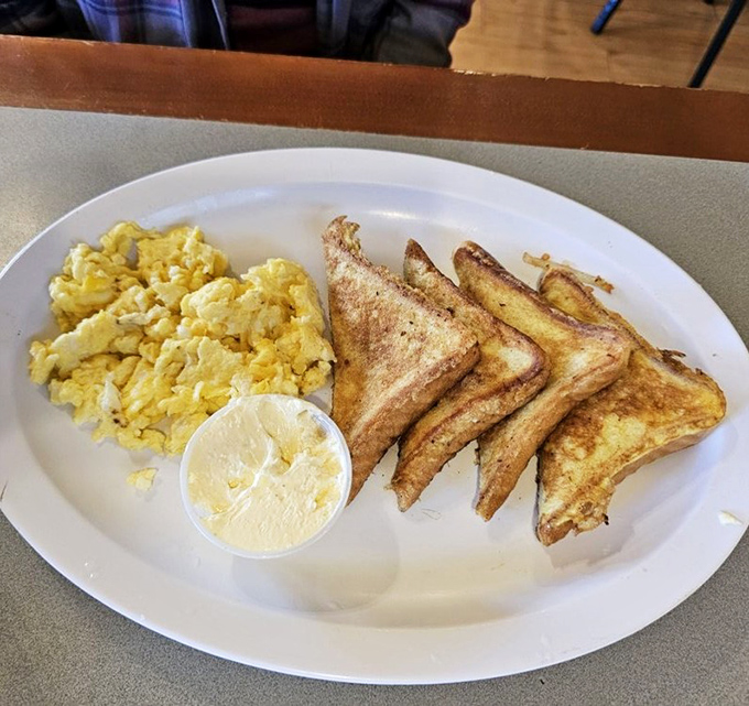 Golden triangles of French toast alongside perfectly scrambled eggs&mdash;simple breakfast perfection that needs no fancy garnish or pretentious description.