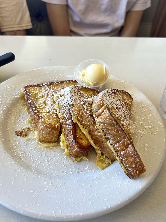French toast that dresses up like dessert but still counts as breakfast. That scoop of butter melting on top is nature's way of saying "enjoy."