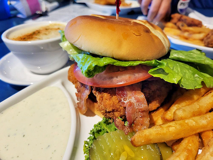 This isn't just a sandwich&mdash;it's a towering achievement of crispy chicken, fresh veggies, and what appears to be bacon's greatest supporting role.