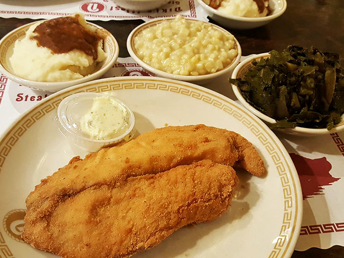 Fried tilapia so perfectly golden it belongs in Fort Knox, flanked by mac and cheese and collard greens that refuse to be mere supporting characters.