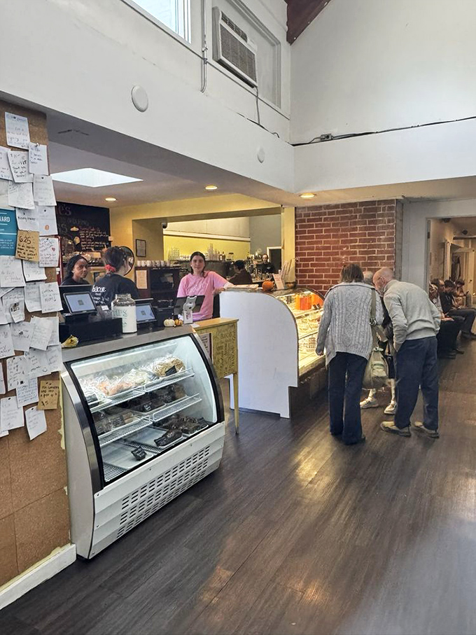 At the counter, pastries tempt from behind glass while staff members orchestrate the morning dance of coffee pouring and order-taking with practiced ease.