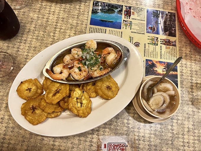 Garlic shrimp swimming in buttery glory, surrounded by plantain islands. A dish so good you'll be plotting your return visit before the plate is empty.