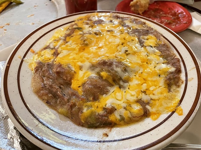 Green Chile Con Carne that doesn't hide behind fancy presentation—just honest-to-goodness flavor that's been building in that pot for hours, topped with melted cheese.