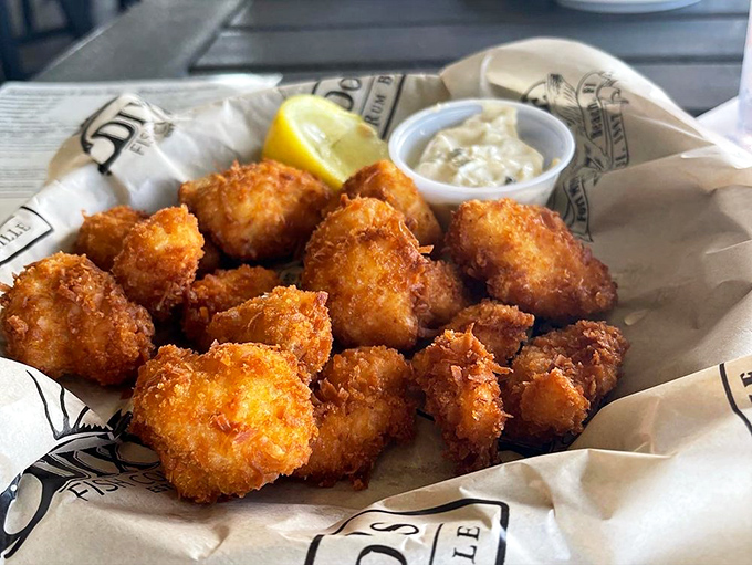 Bite-sized treasures from the deep. These golden-fried grouper bites prove that sometimes the best seafood experiences come in small, shareable packages.