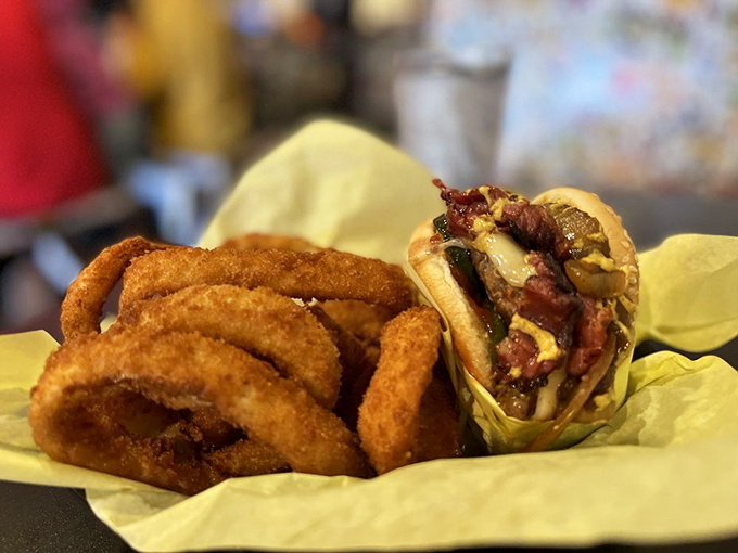 The Guido Burger with onion rings &ndash; a masterclass in contrast where the crispy, golden rings provide the perfect counterpoint to the juicy, flavor-packed burger.