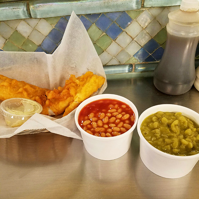 The full British experience on a single tray. Golden fish, chips, mushy peas, and beans create a colorful quartet of flavors that sing in perfect harmony.