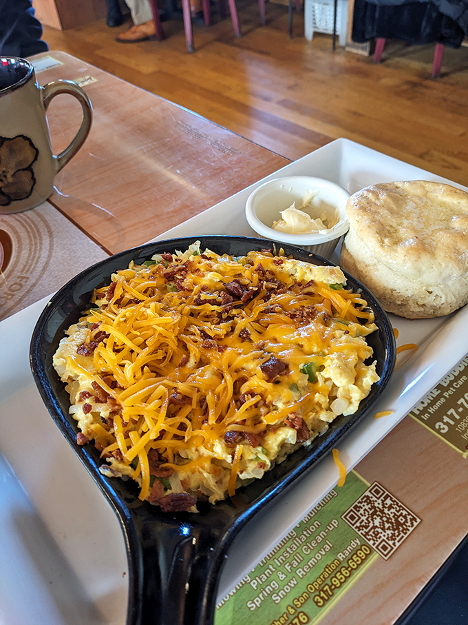 Skillet scrambles: where eggs, cheese, and bacon have a delicious reunion in a hot cast iron pan. That biscuit looks ready for action.