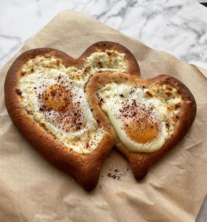 Love takes many forms, but perhaps none as convincing as eggs baked into heart-shaped bread with a generous dusting of spice.