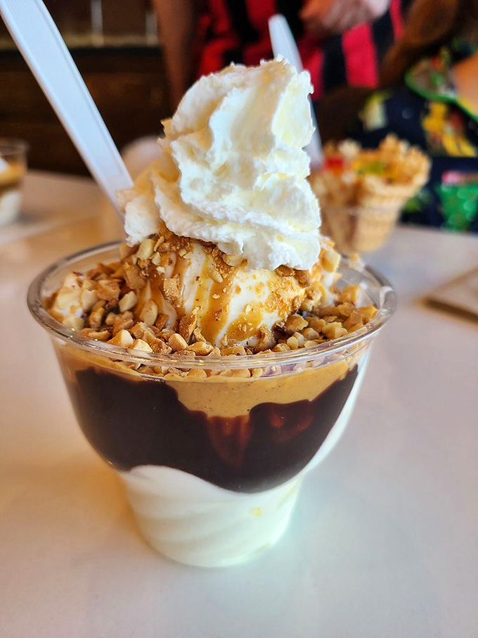 Hot fudge cascading down vanilla custard with a crown of whipped cream and nuts. This sundae doesn't just satisfy cravings&mdash;it silences them.