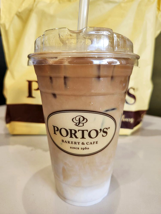 This iced latte isn't just a coffee&mdash;it's summer vacation in a cup, complete with the Porto's logo as your passport to caffeinated bliss.