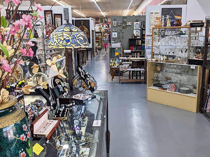 Tiffany-style lamps cast colorful shadows across aisles of treasures, creating the perfect lighting for spotting that must-have collectible.