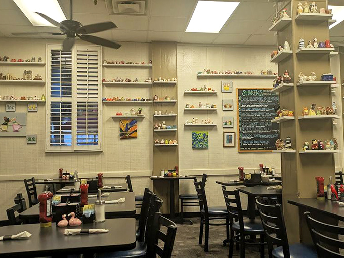 Ceiling fans keep the Florida air moving while diners enjoy their meals beneath shelves of collectible shakers. Breakfast with a side of nostalgia. 