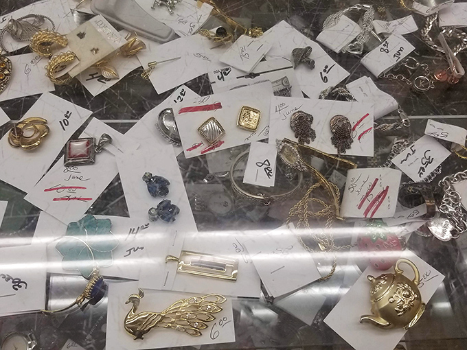 Tiny treasures under glass, each tagged with possibility. That vintage brooch might have attended fancy parties before landing here.